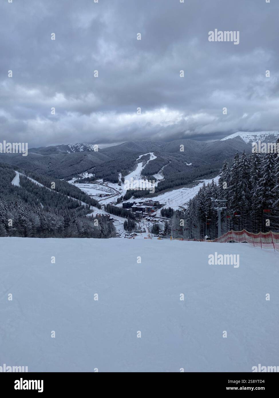 Snowy Ski Resort with Slopes and Pine Trees Stock Photo - Alamy