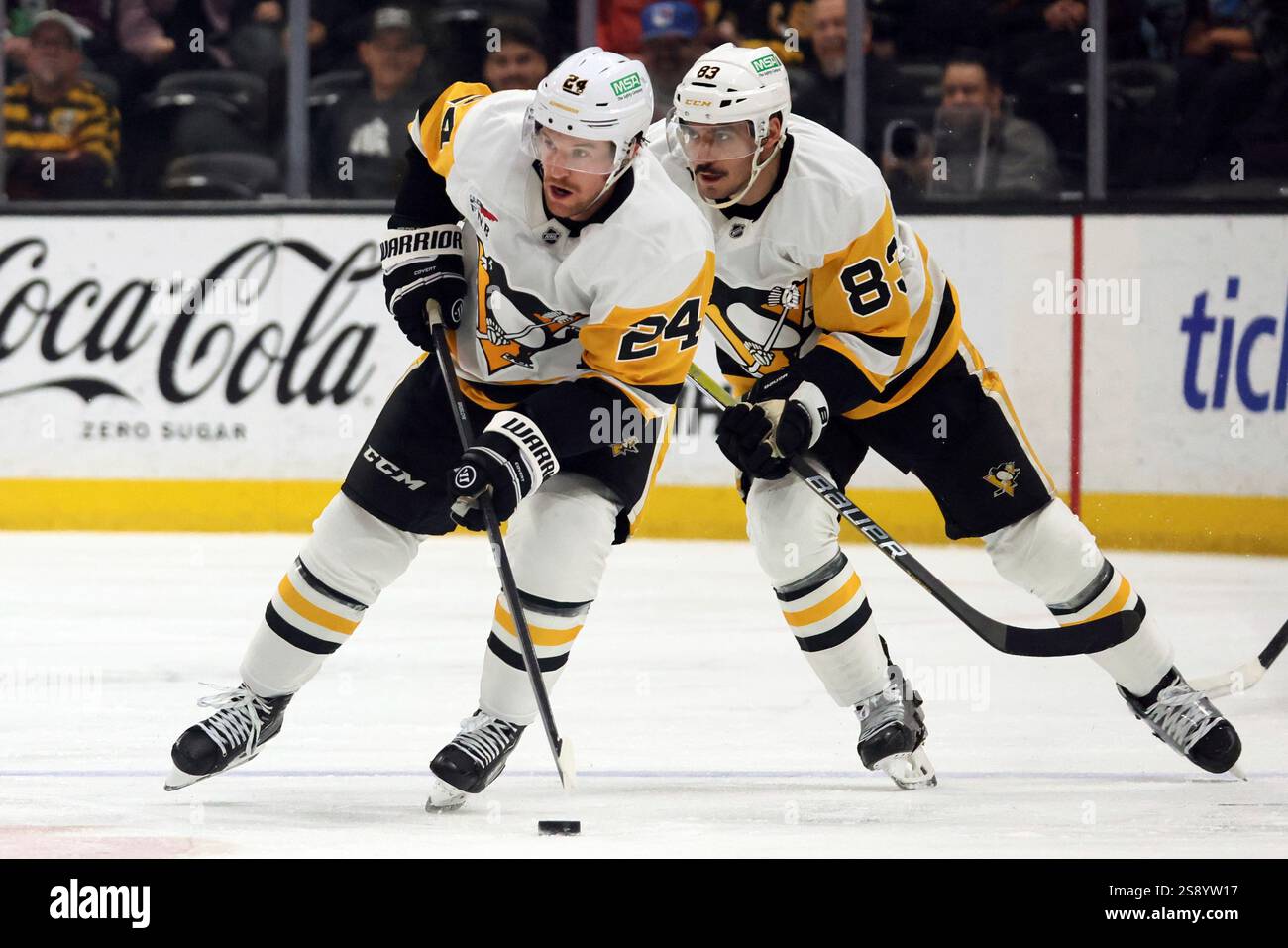 Pittsburgh Penguins defenseman Matt Grzelcyk, left, controls the puck ...