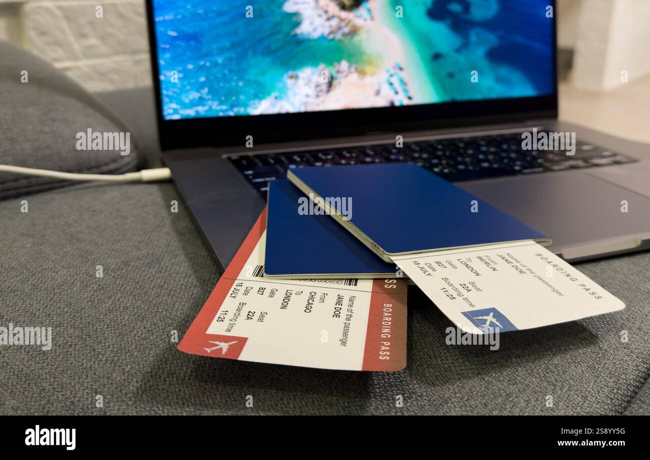 Airline boarding passes with passport, laptop Stock Photo - Alamy