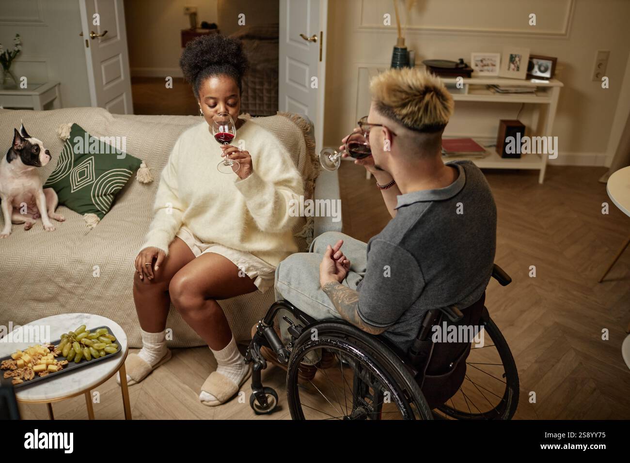 High angle shot of multiethnic couple tasting delicious red wine having ...