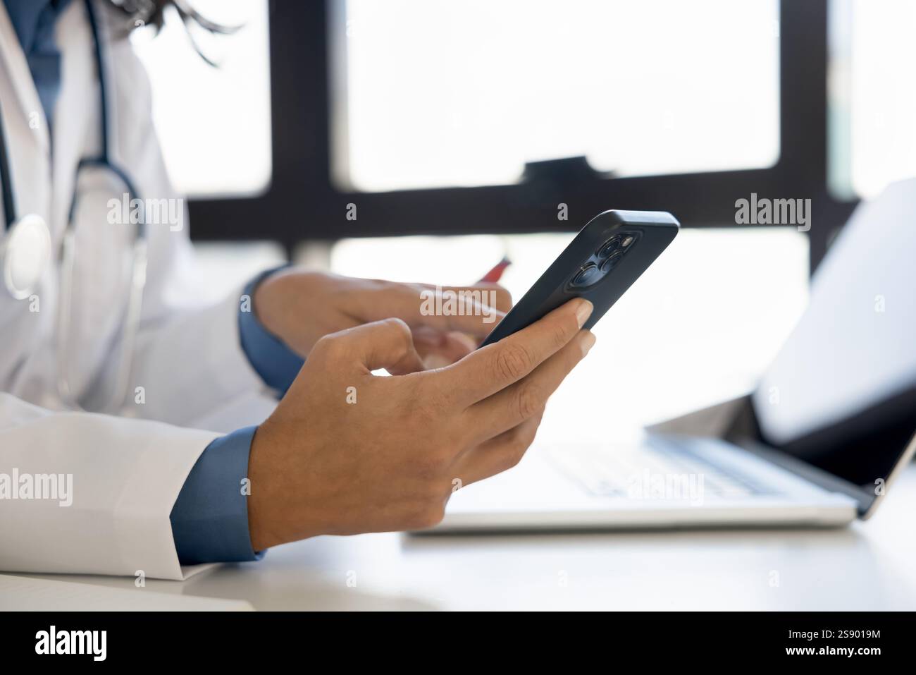 Cropped closeup female medical worker hands using modern mobile phone ...