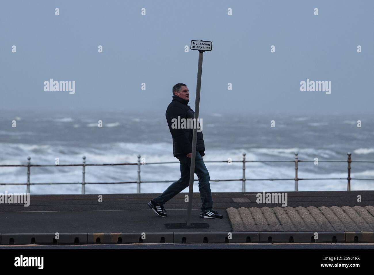 A man struggles to walk in high winds as Storm Éowyn batters Blackpool ...