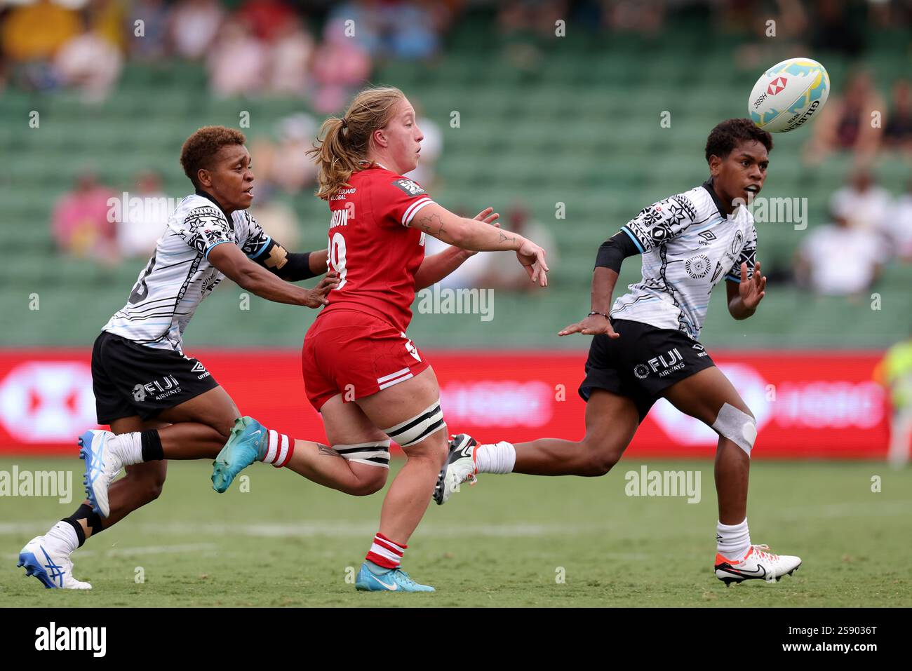 Mahalia Robinson of Canada passes the balls against Fiji during the ...