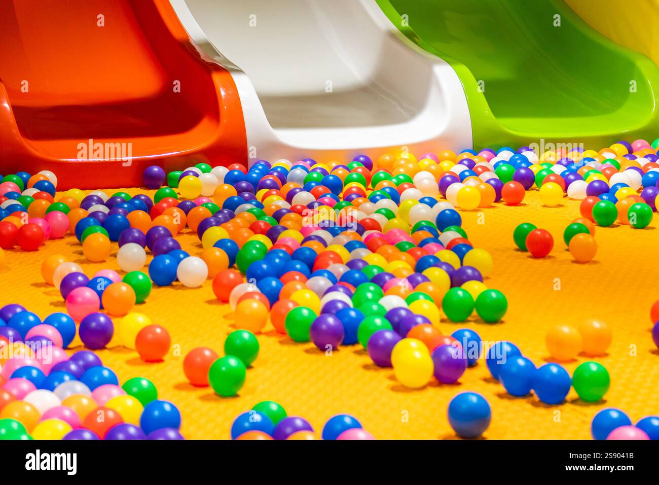 A colorful playground with vibrant slides and a lively ball pit for ...
