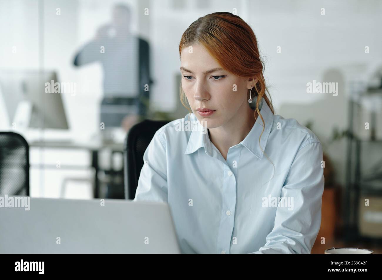 Woman working focused on laptop hi-res stock photography and images - Alamy