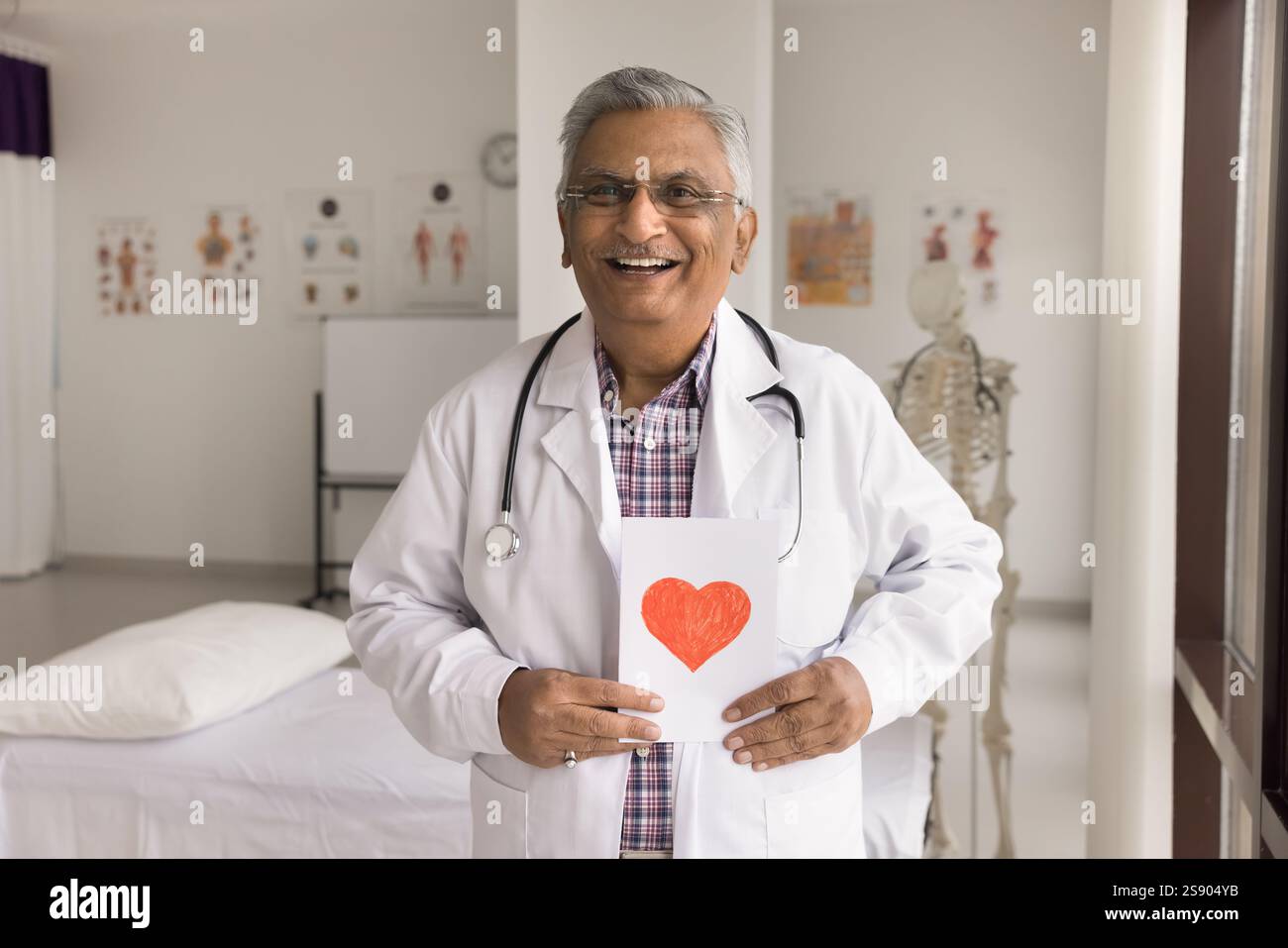 Happy senior doctor cardiologist show you picture with read heart Stock ...