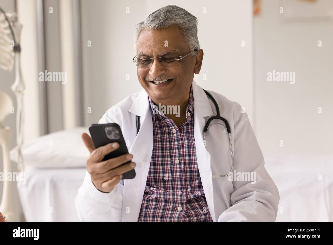 Smiling mature doctor read message from grateful patient on phone Stock ...
