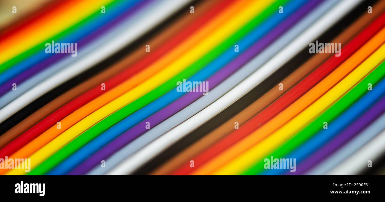 Flat cables in various colors are neatly aligned, creating a striking ...