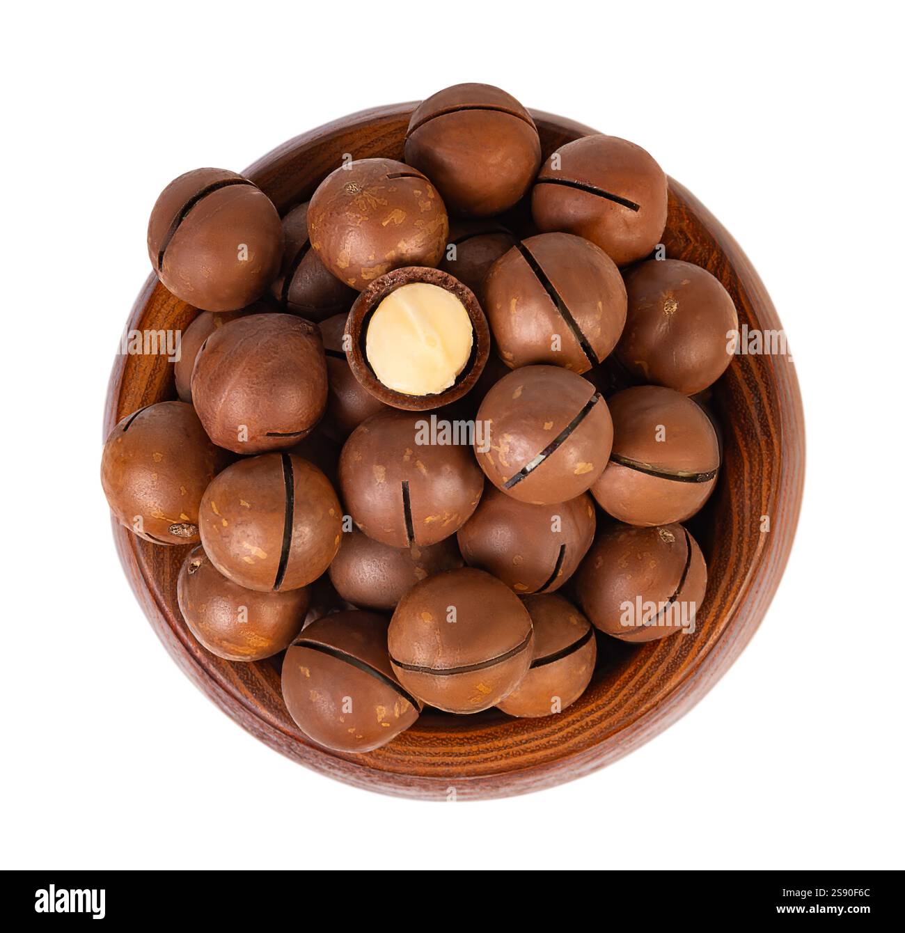 A bowl filled with macadamia nuts displays their round shape and light ...