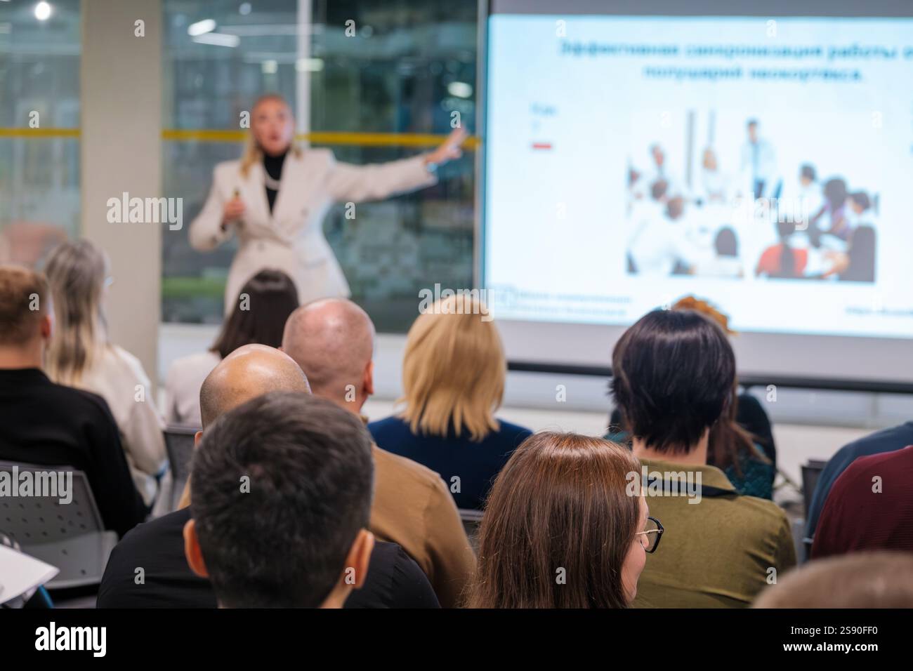 Corporate seminar session with a presenter addressing an engaged ...