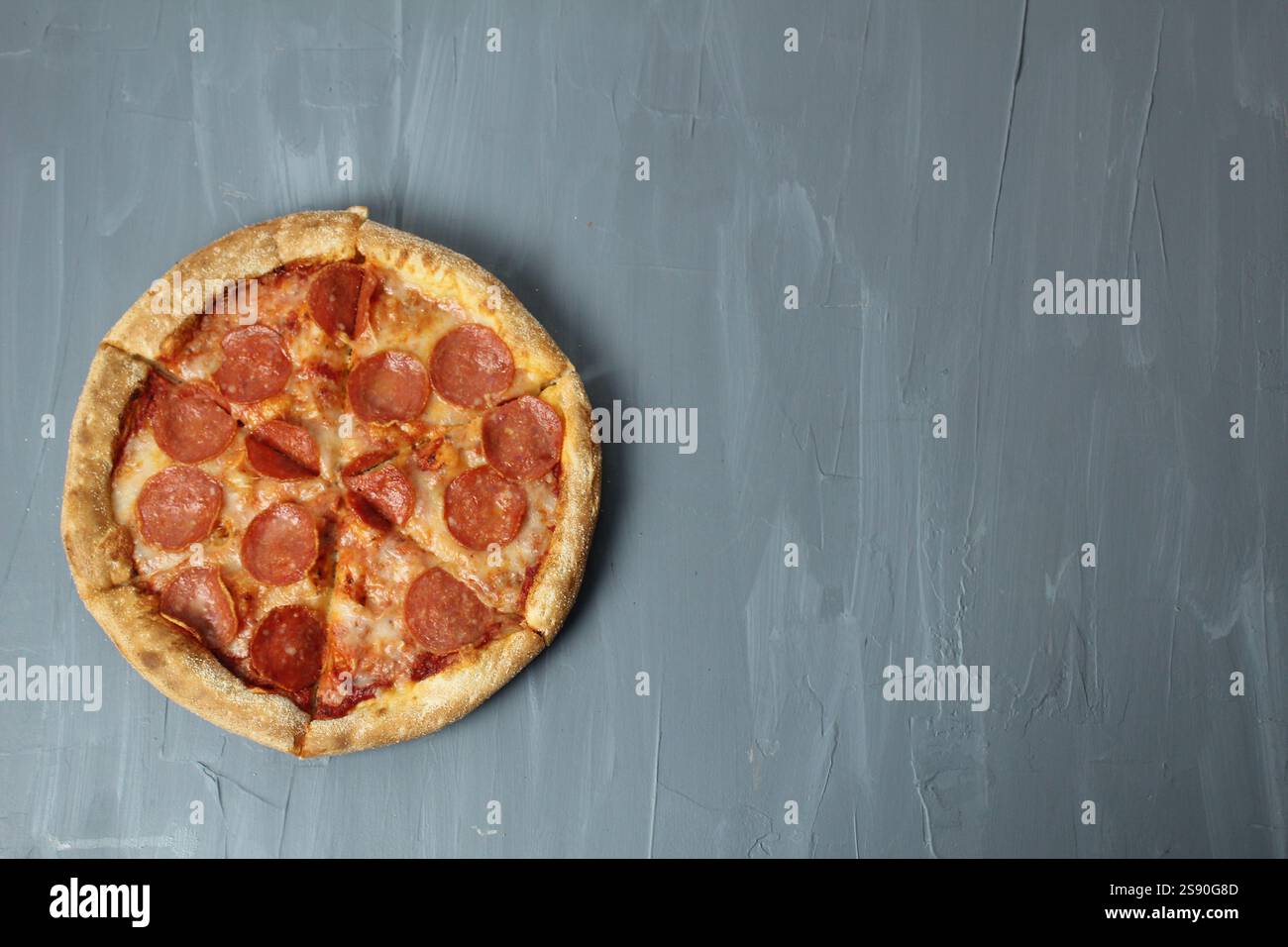Round pepperoni on pizza on a gray background, upper angle. Pepperoni ...
