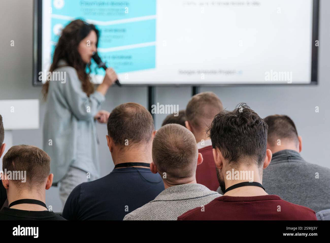 Business seminar speaker engaging audience with presentation. Attendees ...