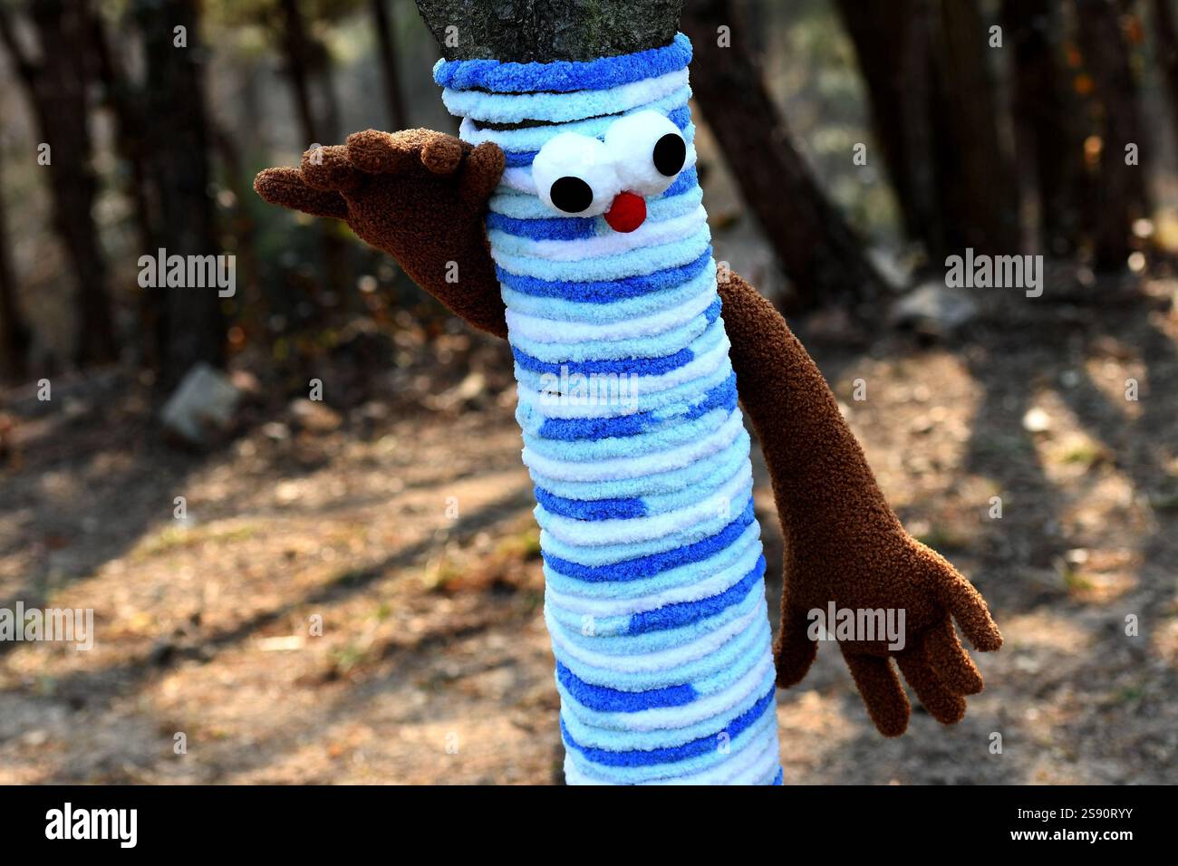 Trees in a park are put on brightly colored "sweaters" for winter in ...