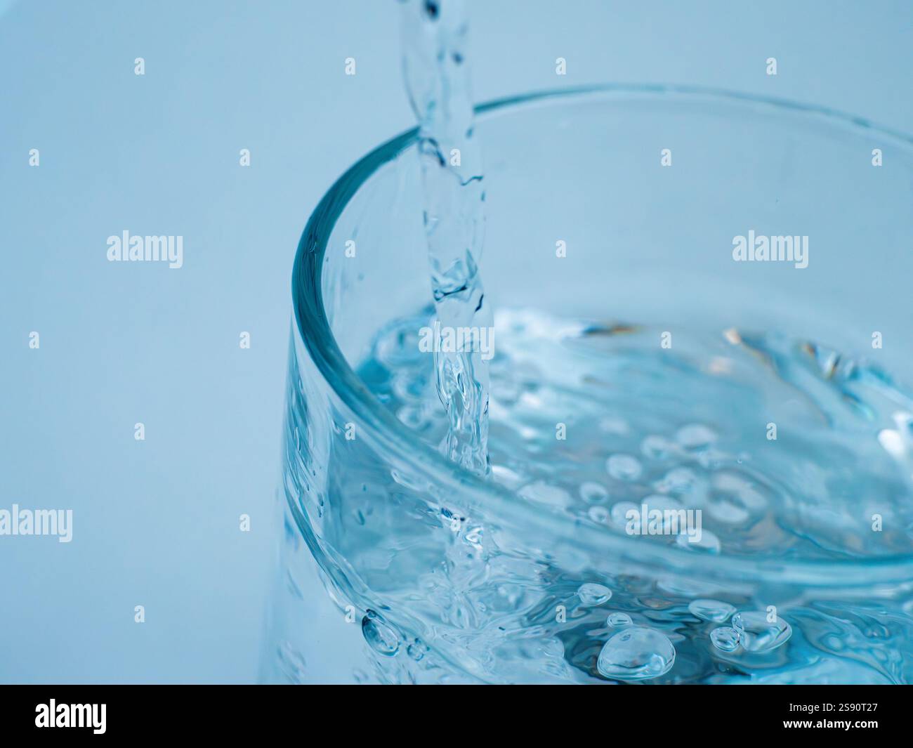 Water being poured into a clear glass Stock Photo - Alamy