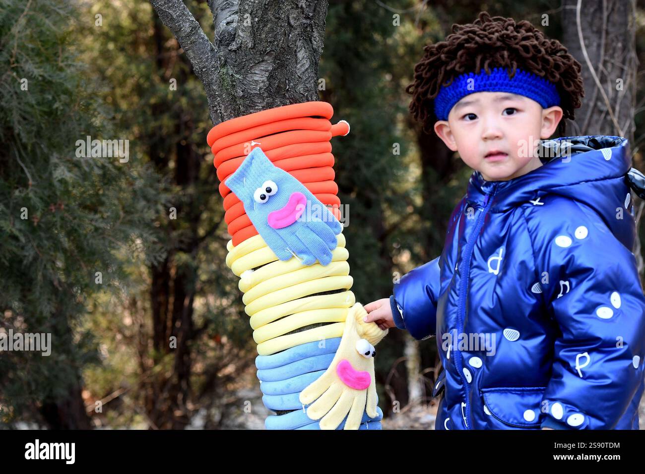 Trees in a park are put on brightly colored "sweaters" for winter in ...