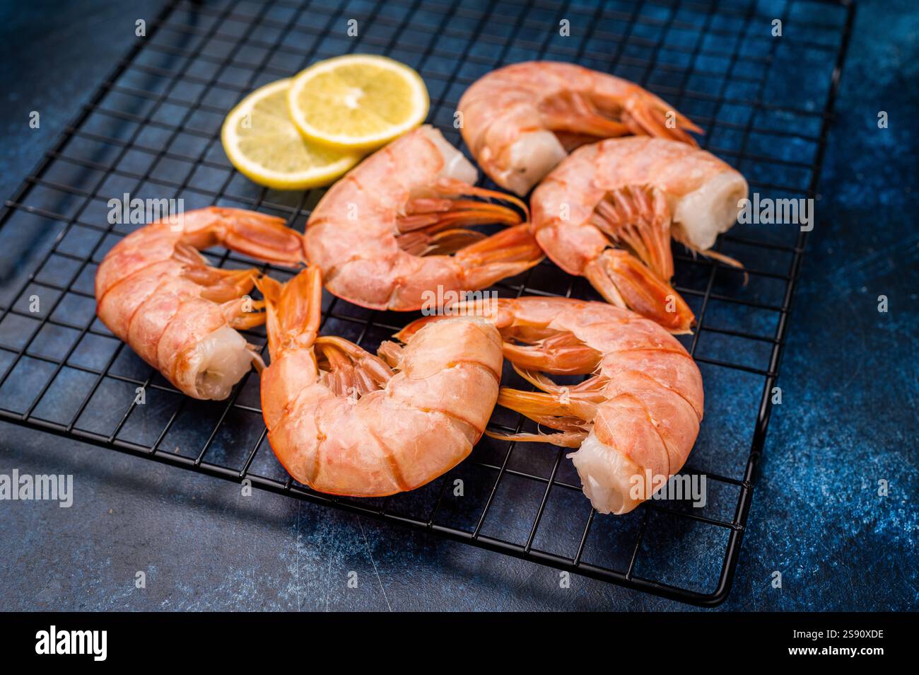 Ready for cooking Headless Red shrimps, raw Prawns on a rack. blue ...