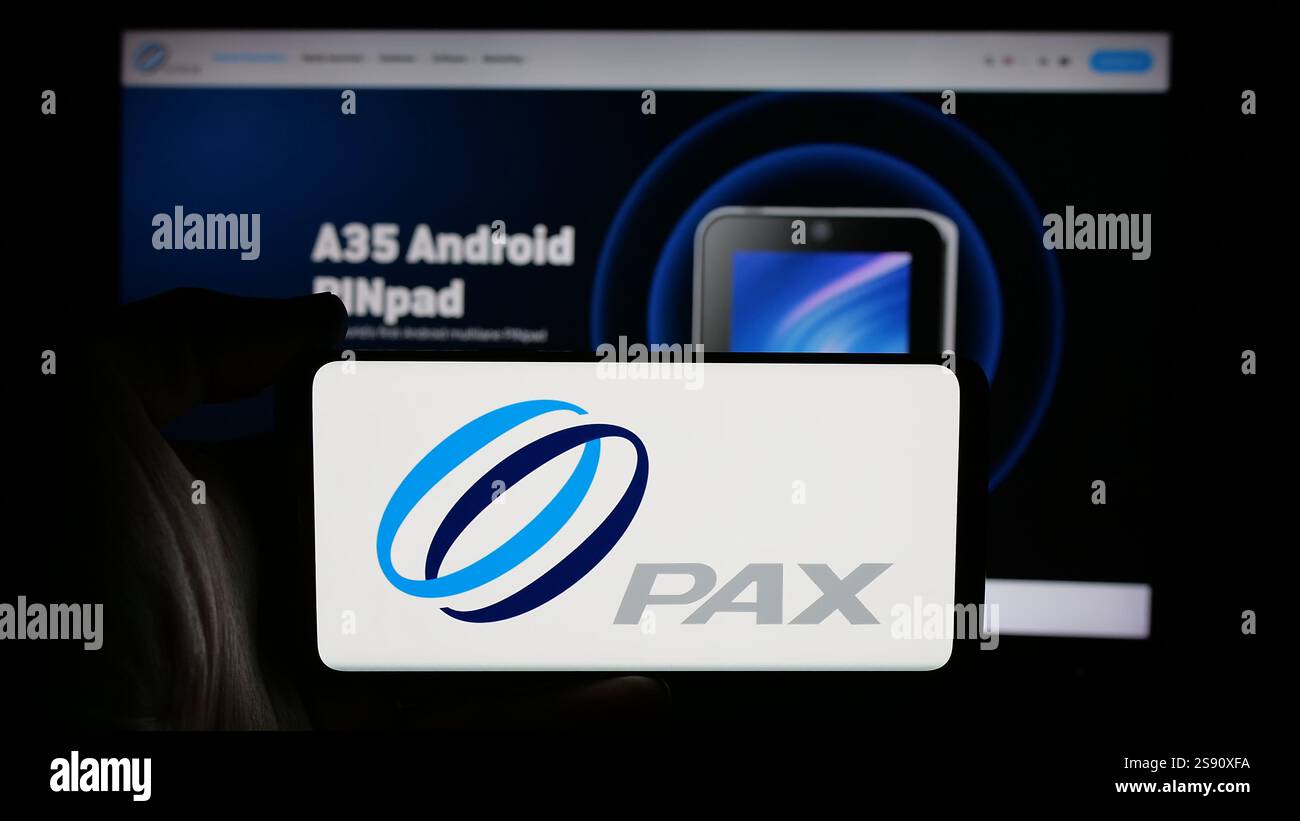 In this photo illustration, a person is holding a cellphone with the logo of Chinese payment ...