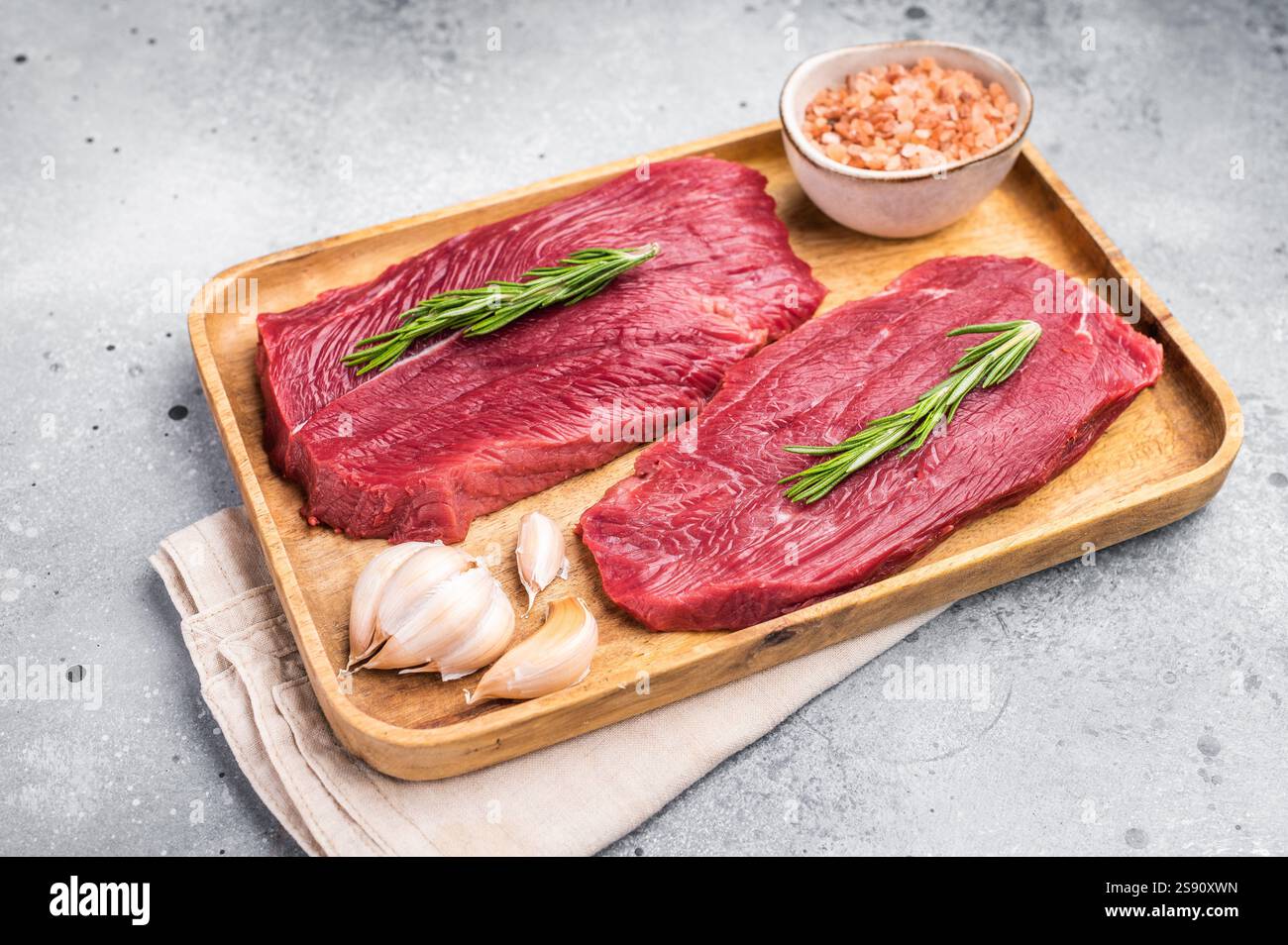 Raw Ostrich steaks, fresh Game Meat in wooden tray. grey background ...