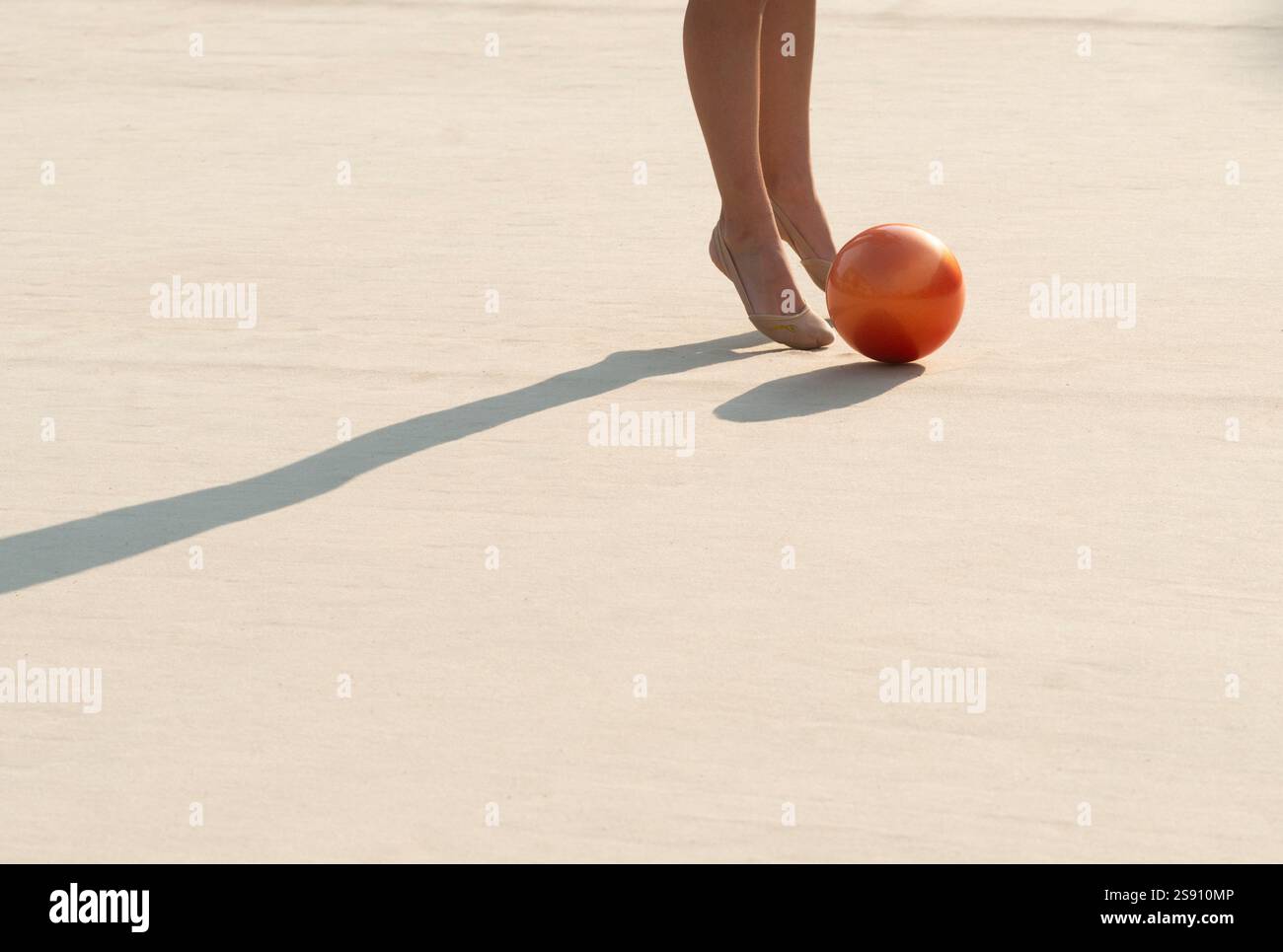 Exhibition Rhythmic Gymnast Performs with a Orange Ball Stock Photo - Alamy