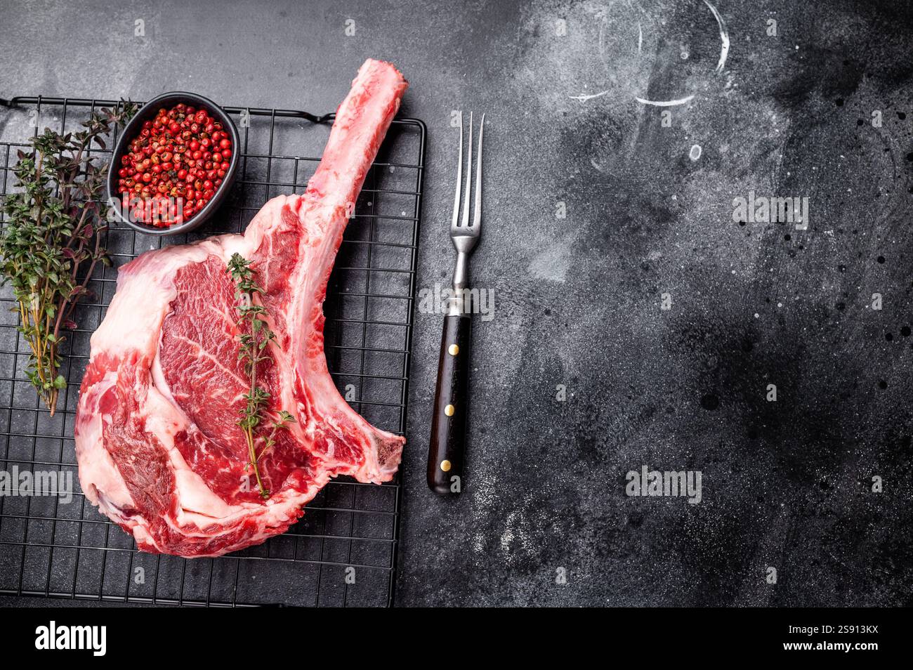 Uncooked tomahawk steak, raw black angus beef rib eye with bone. black ...