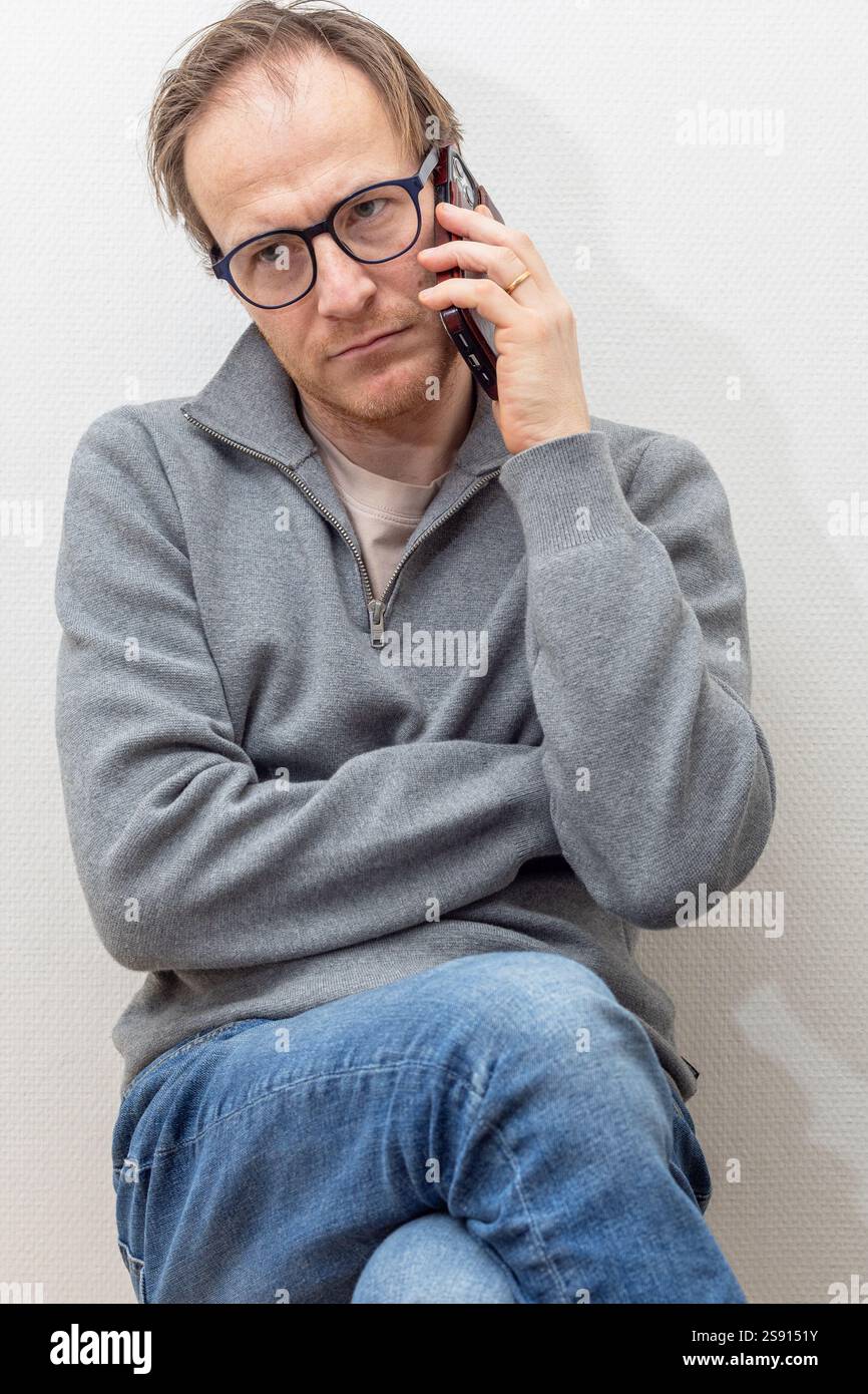 Seated man engaged hi-res stock photography and images - Alamy