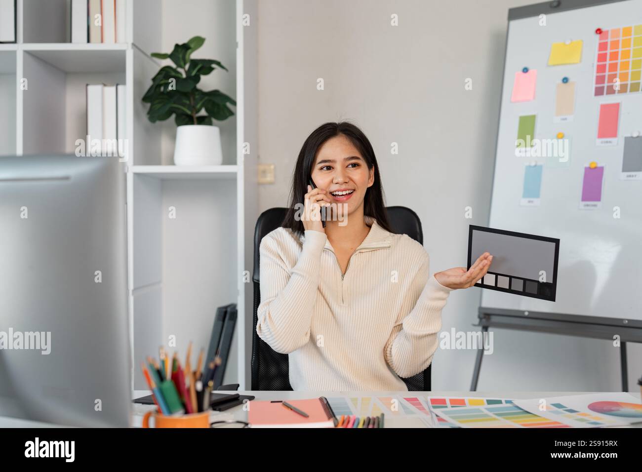 Enthusiastic graphic designer on a call presenting color palettes in a ...