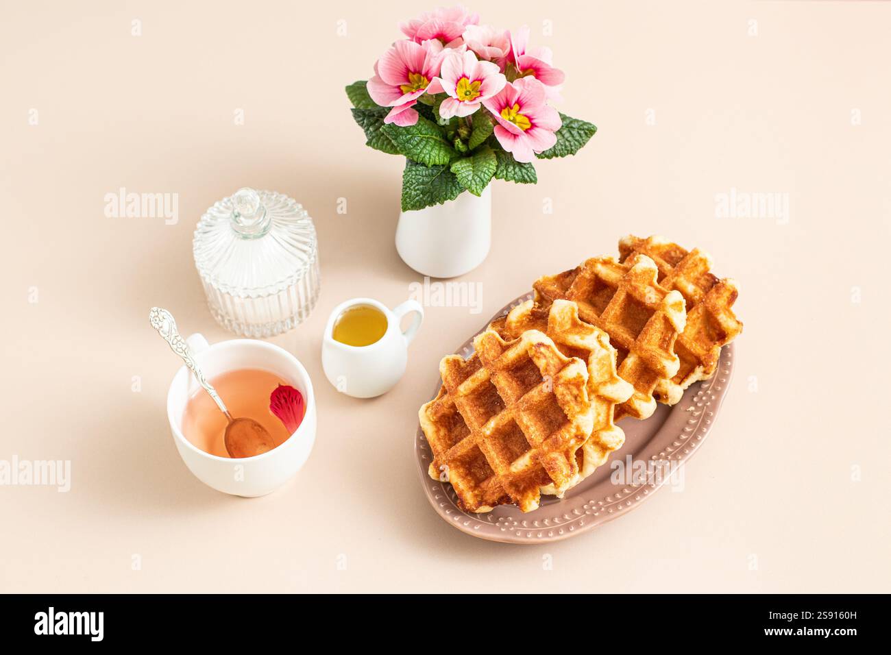 Still life with Viennese Waffles with Tea in Soft Beige Stock Photo - Alamy