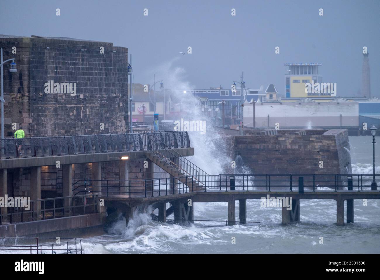 A jogger takes a dangerous run along the millennium promenade in front ...