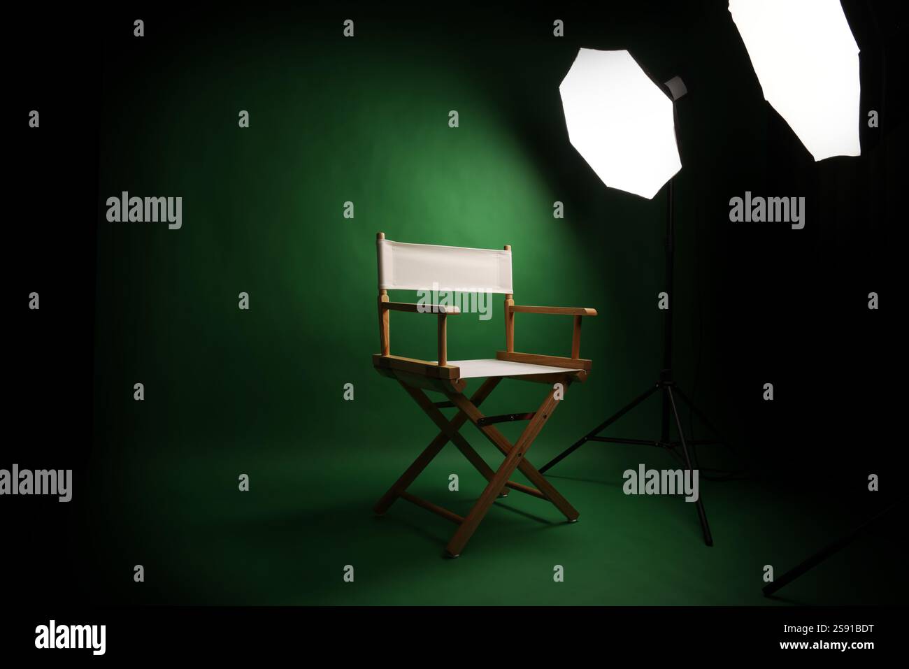 Photo studio with green screen background and wooden stool against ...