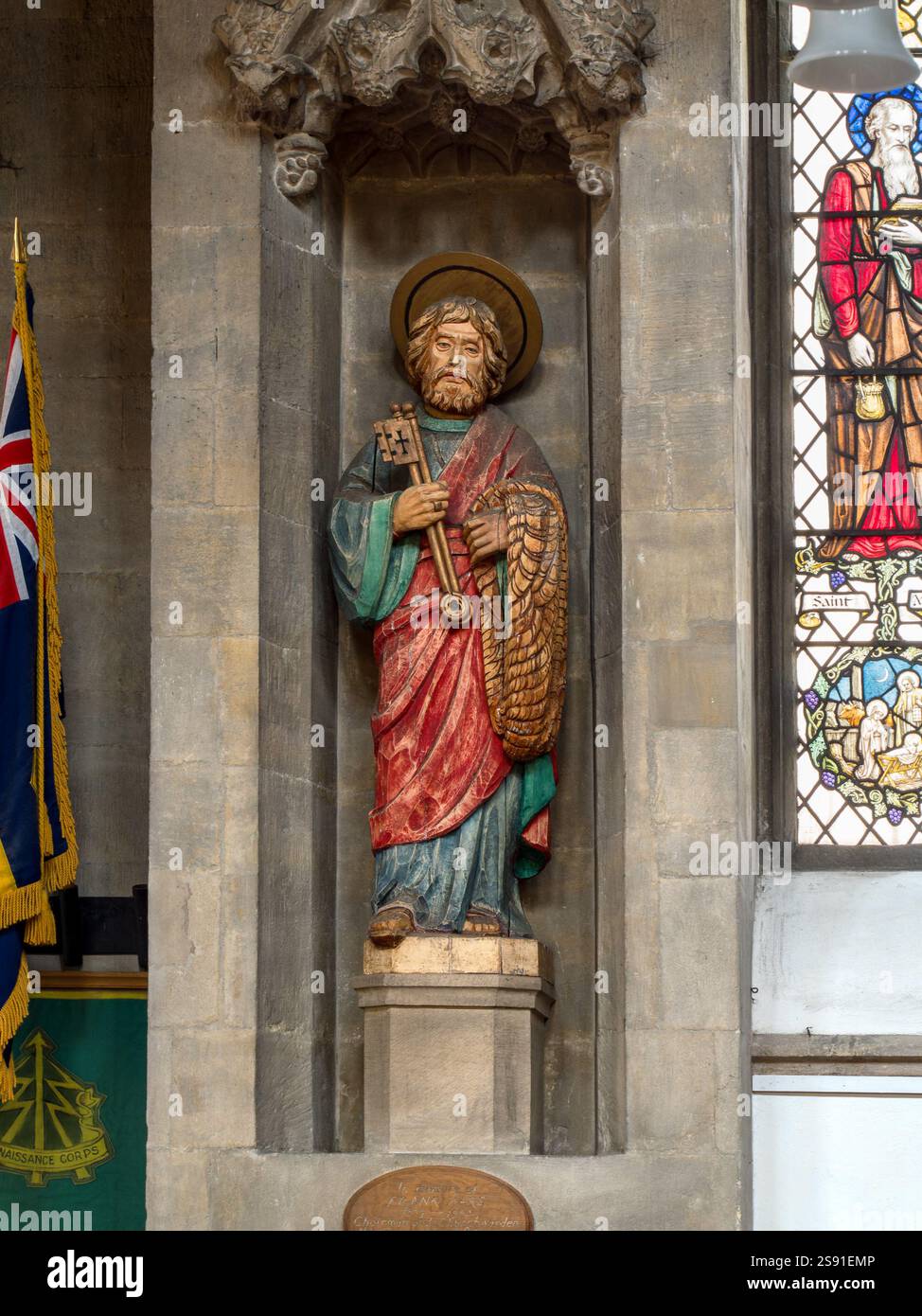Colourful carved and painted figurine of St. Peter in All Saints Church ...