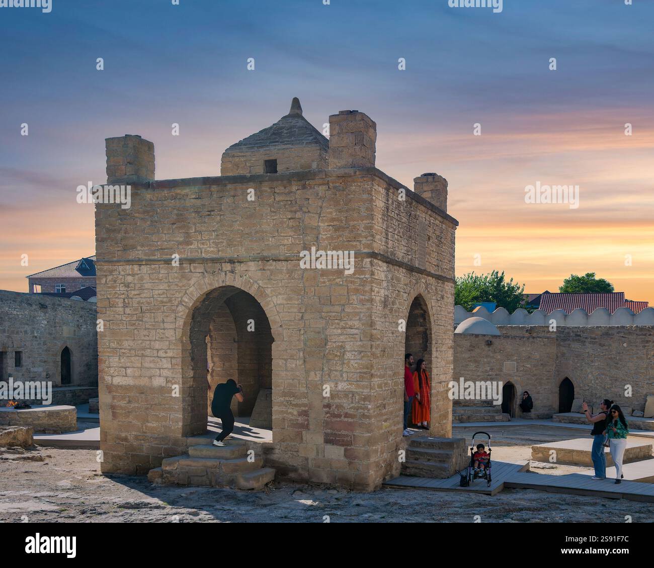 Baku, Azerbaijan - May 9, 2024: Tourists gather in the courtyard of the ...