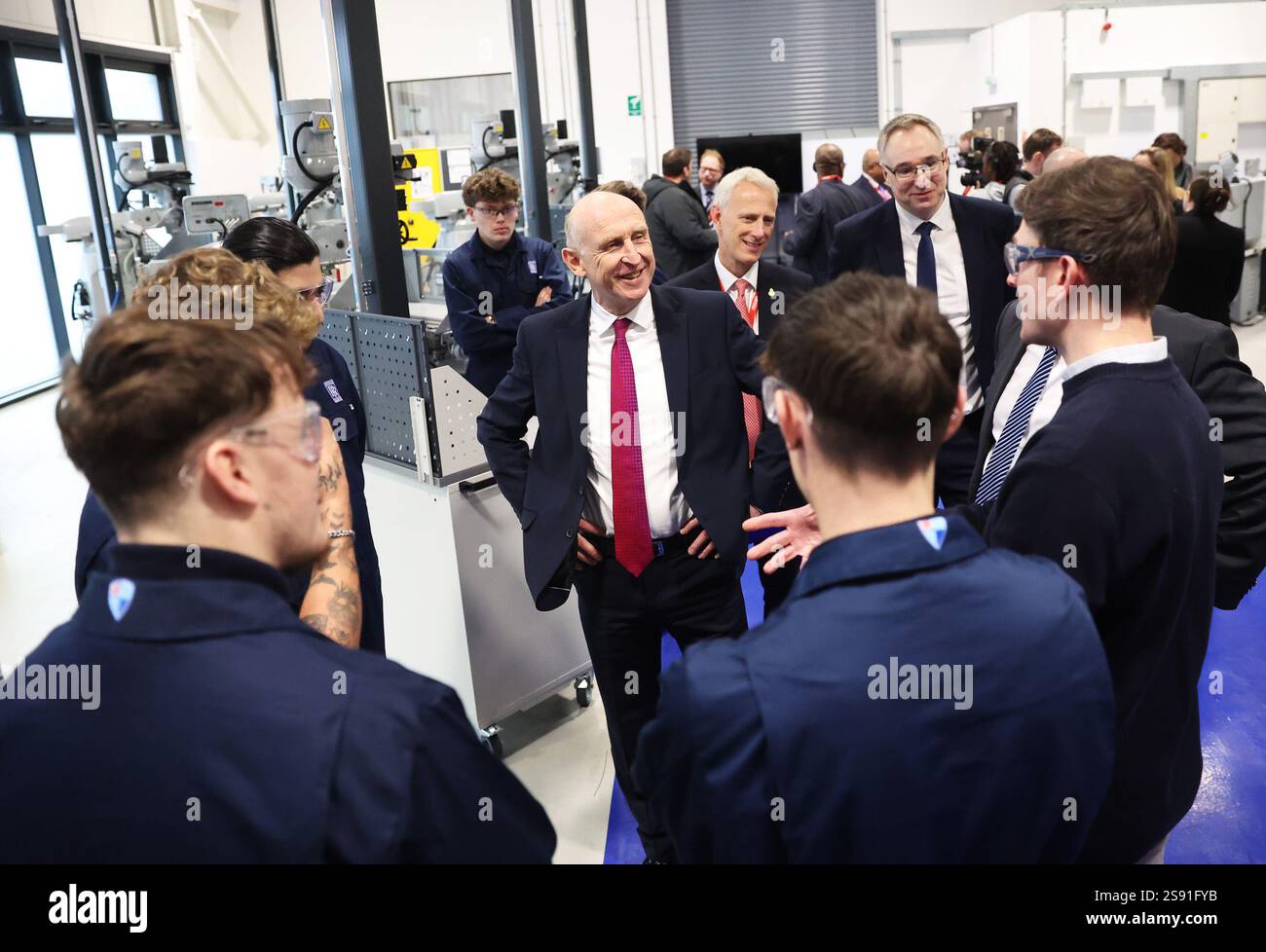 Defence Secretary John Healey (centre) speaks to apprentices during his ...