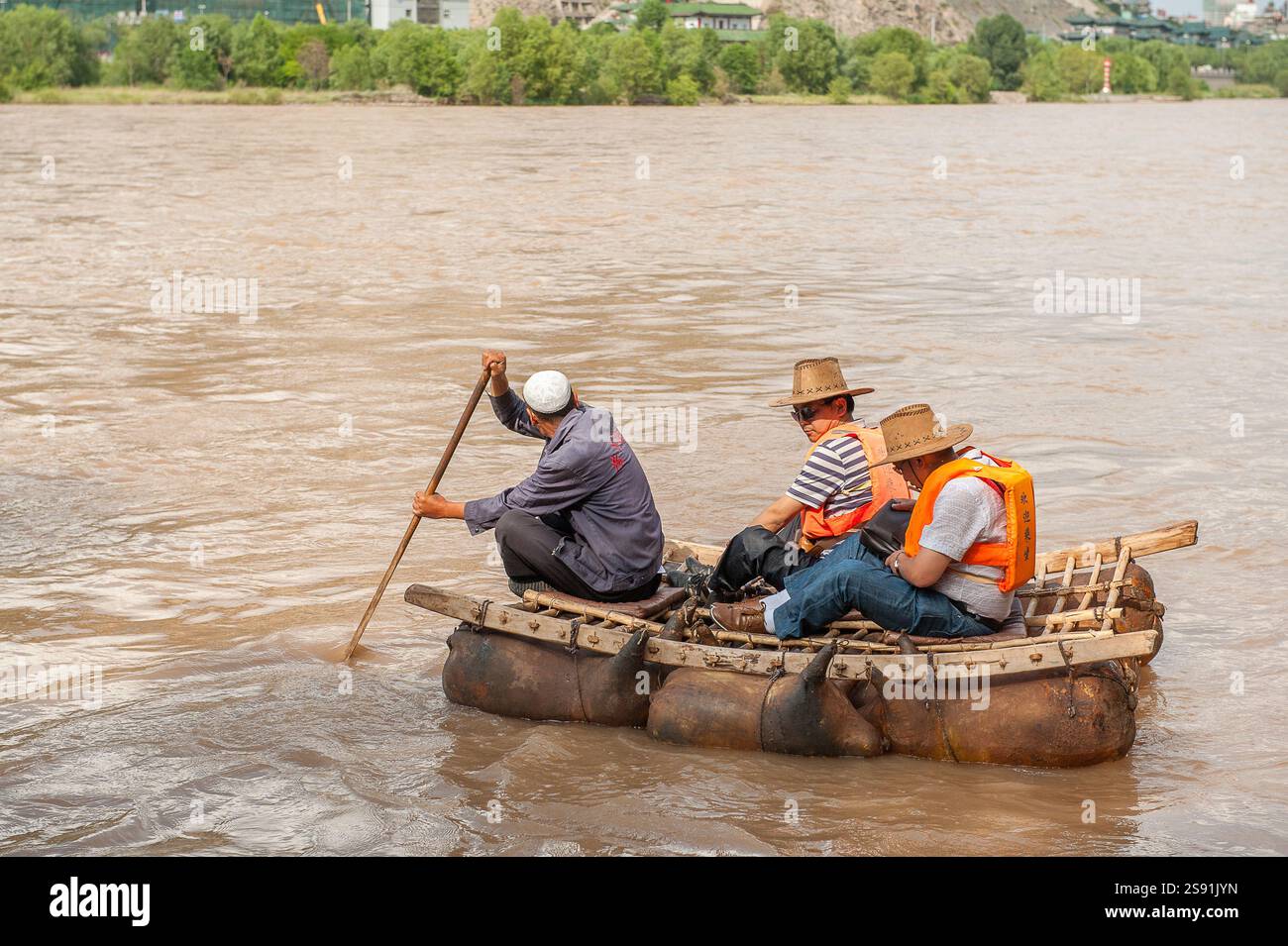 Traditional sheepskin raft departing from Lanzhou Waterwheel Garden on ...