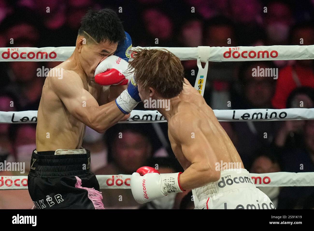Japanese champion Naoya Inoue, right, delivers a punch as he competes ...