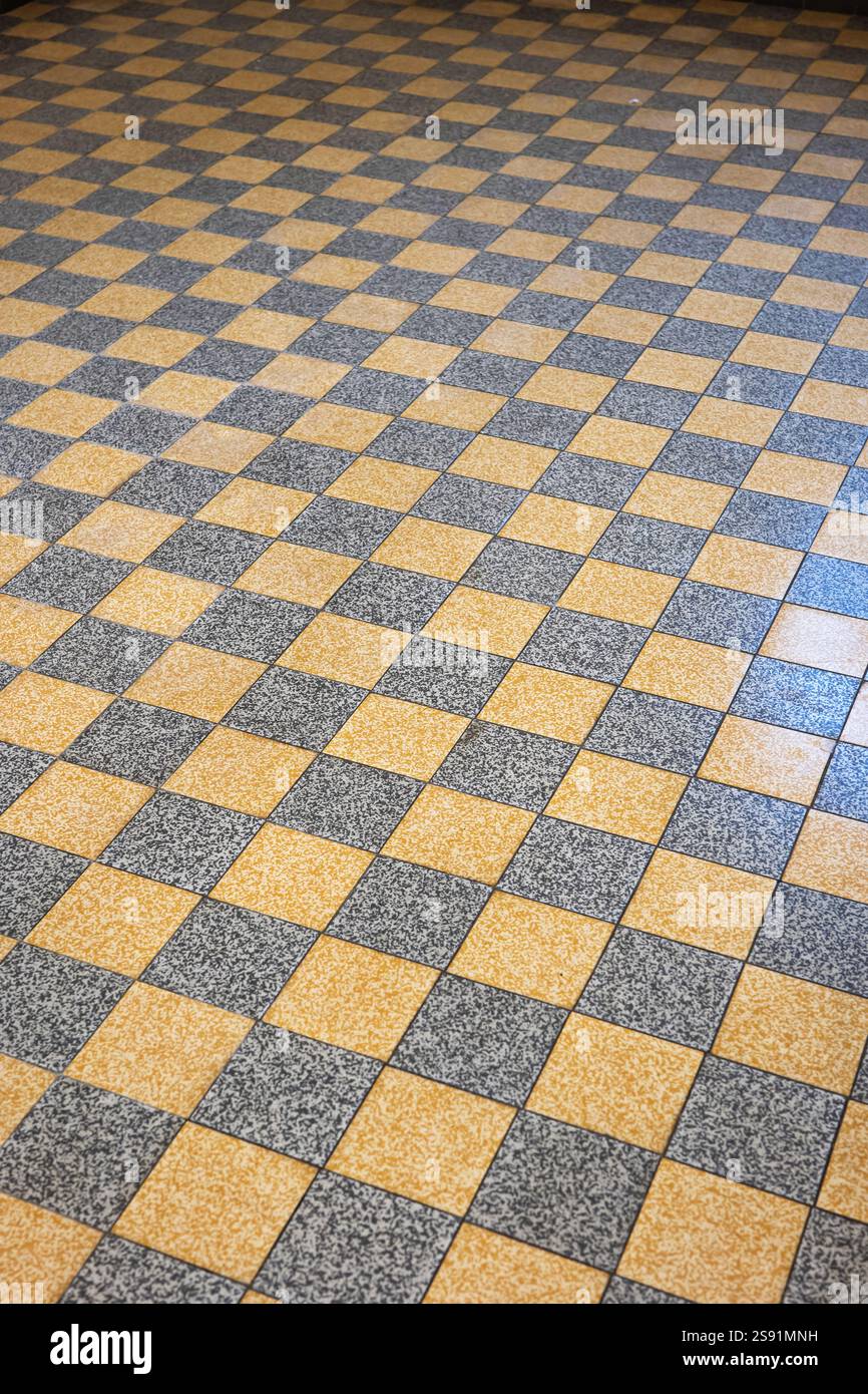Square black and orange mosaic tile floor inside building. Top view ...