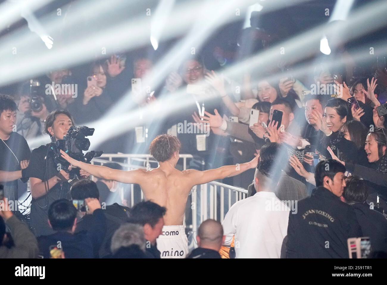 Fans cheer as Japanese champion Naoya Inoue leave the ring after defending his unified WBC IBF ...