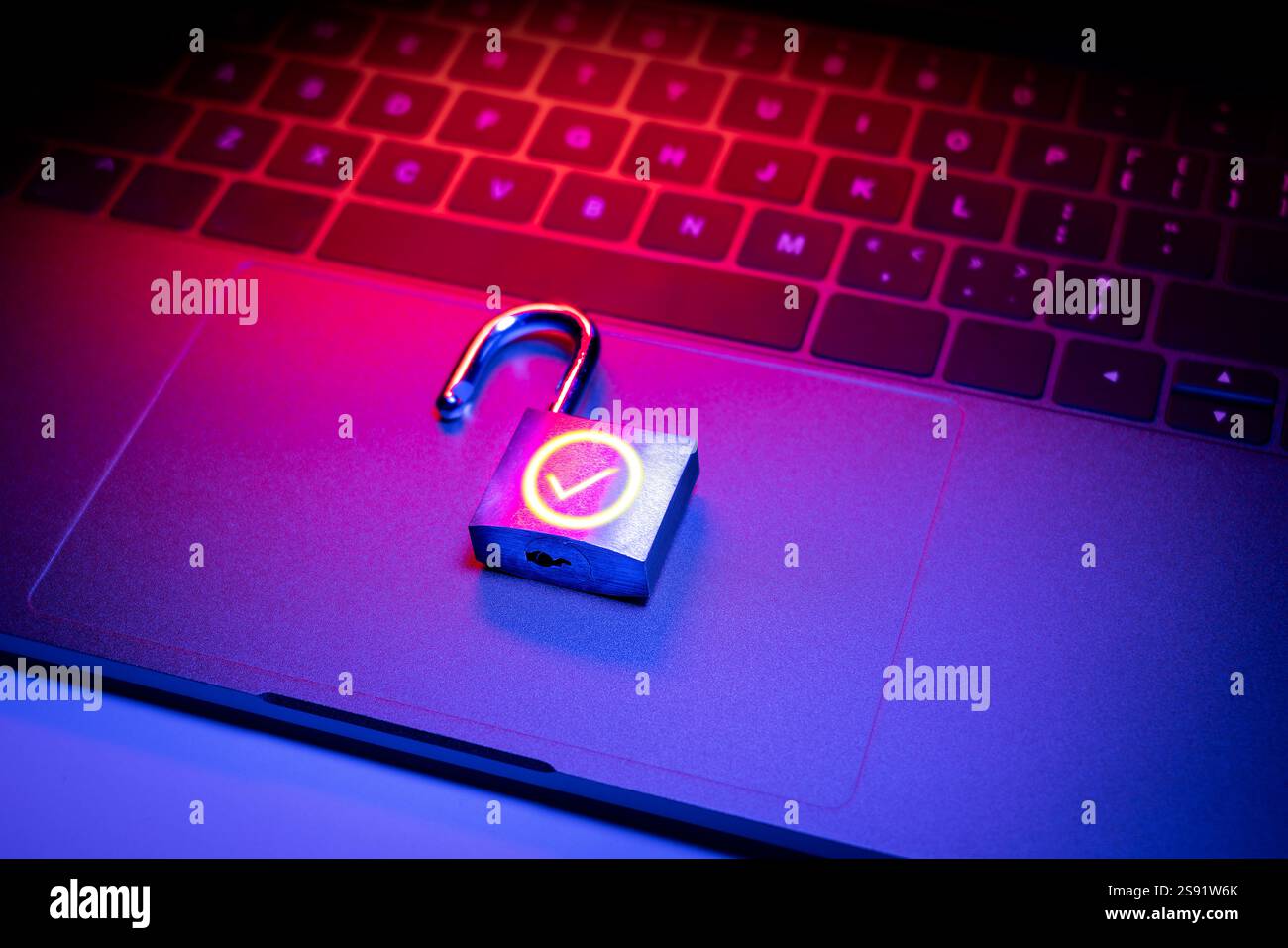 Closeup of a padlock lying on an computer surface. The padlock is ...