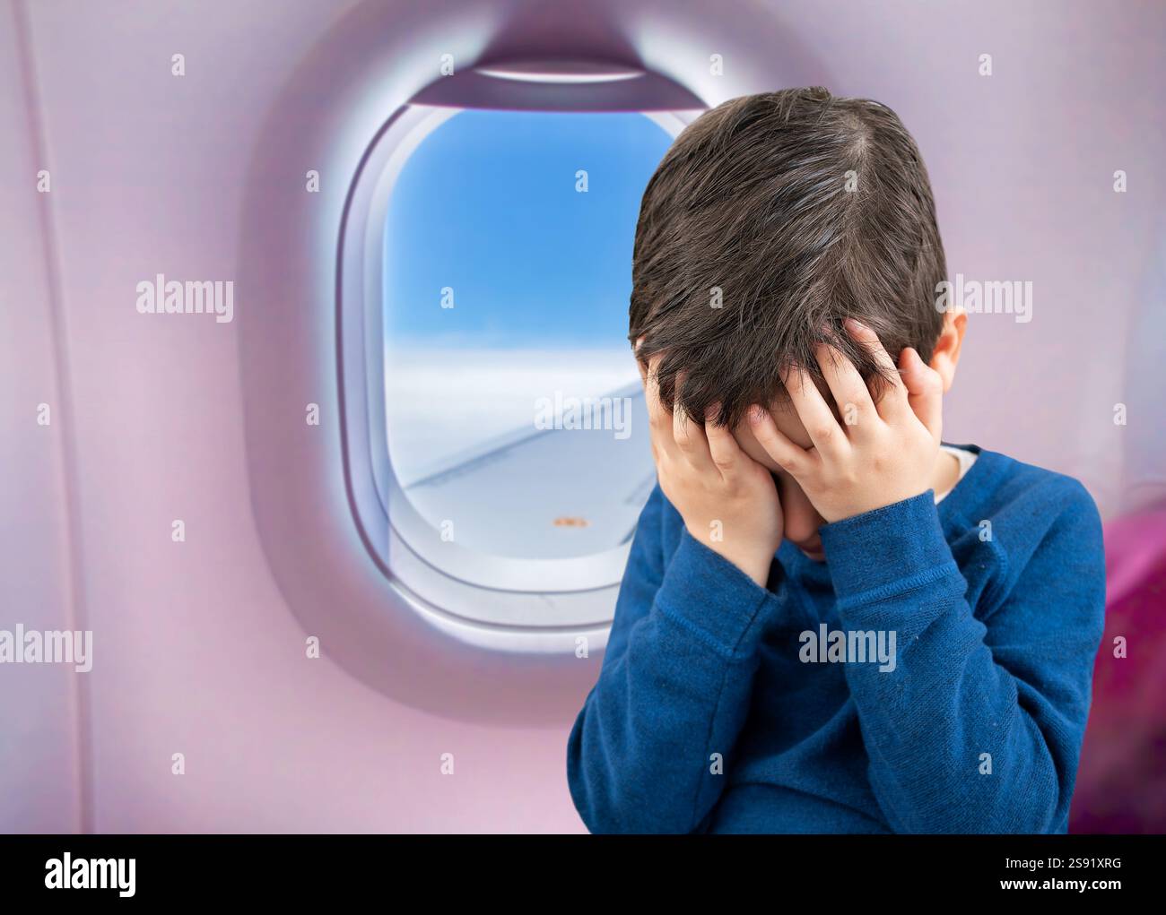 Close-up view of a child covering his face and crying.Headache in the ...