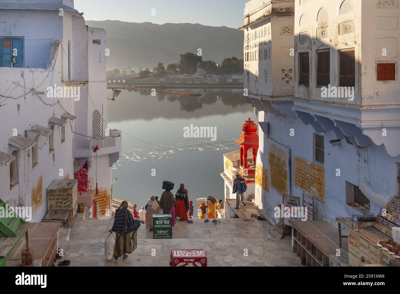 Morning atmosphere, people walking down to the lake shore, old town of ...