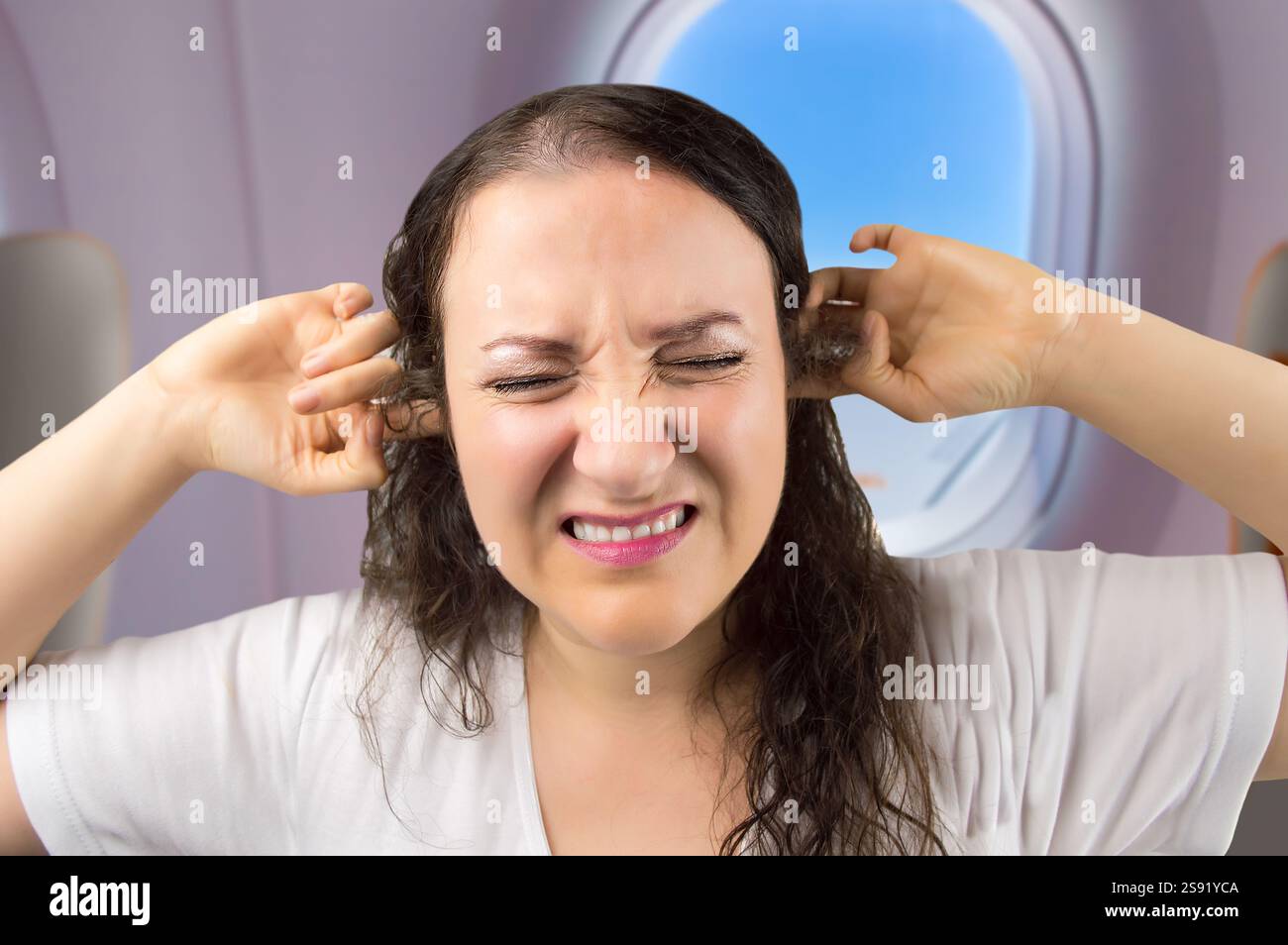 Woman having ear pop on the airplane while taking off Stock Photo - Alamy