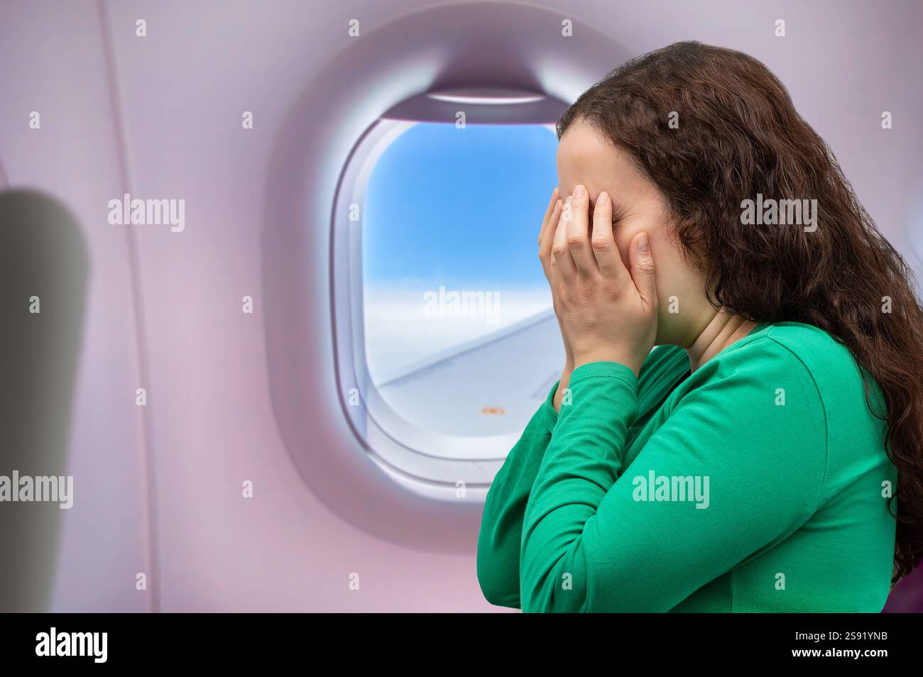 Close-up view of a woman covering her face and crying.Headache in the ...