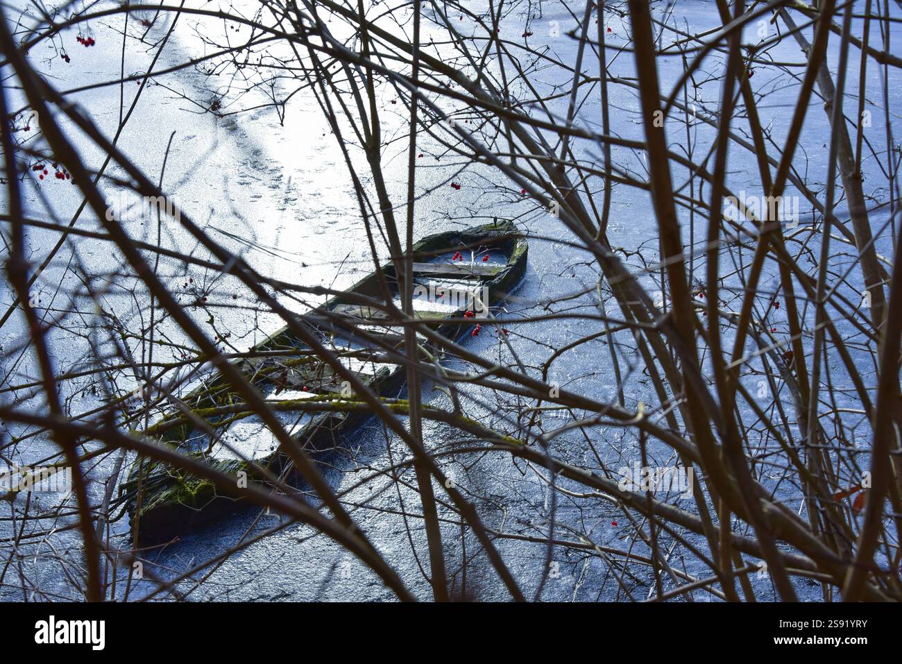 Winter atmosphere with a fragile old boat on a frozen pond, Bavaria ...