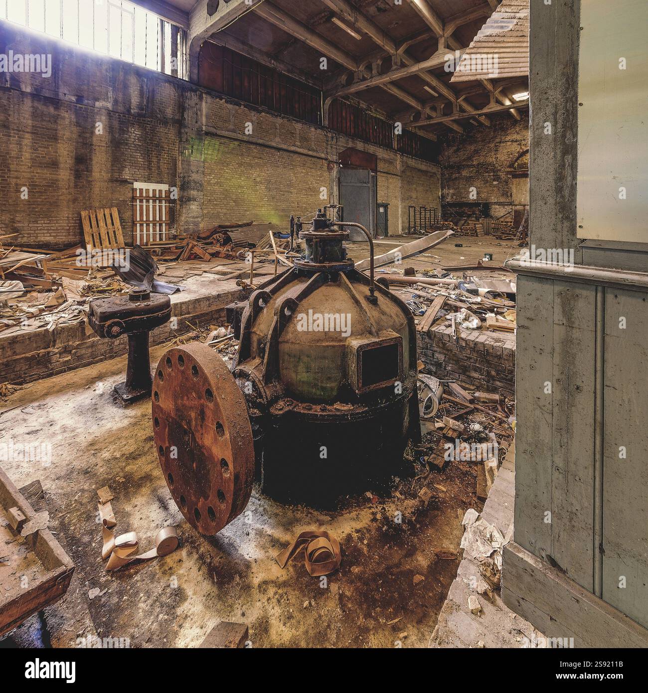 Abandoned factory building with rusty equipment and brick walls ...