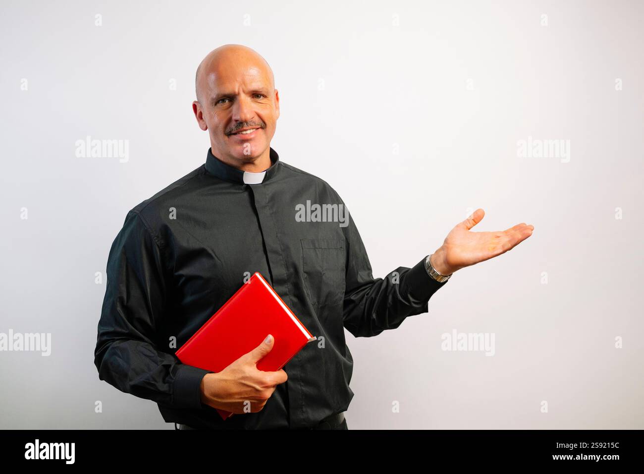 Hispanic man priest pointing bible hi-res stock photography and images ...