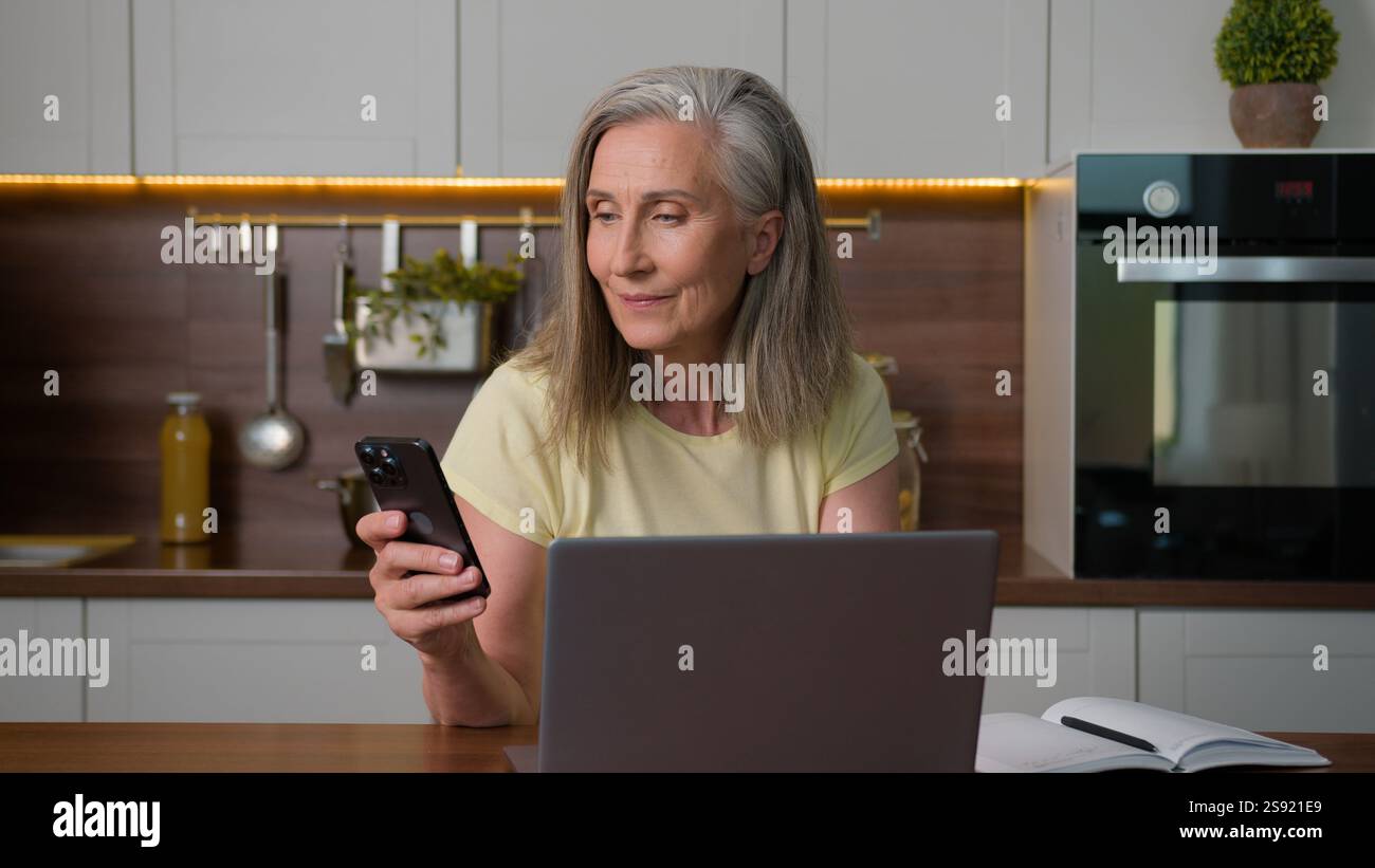 Mature 50s business woman wife online working with computer distance ...