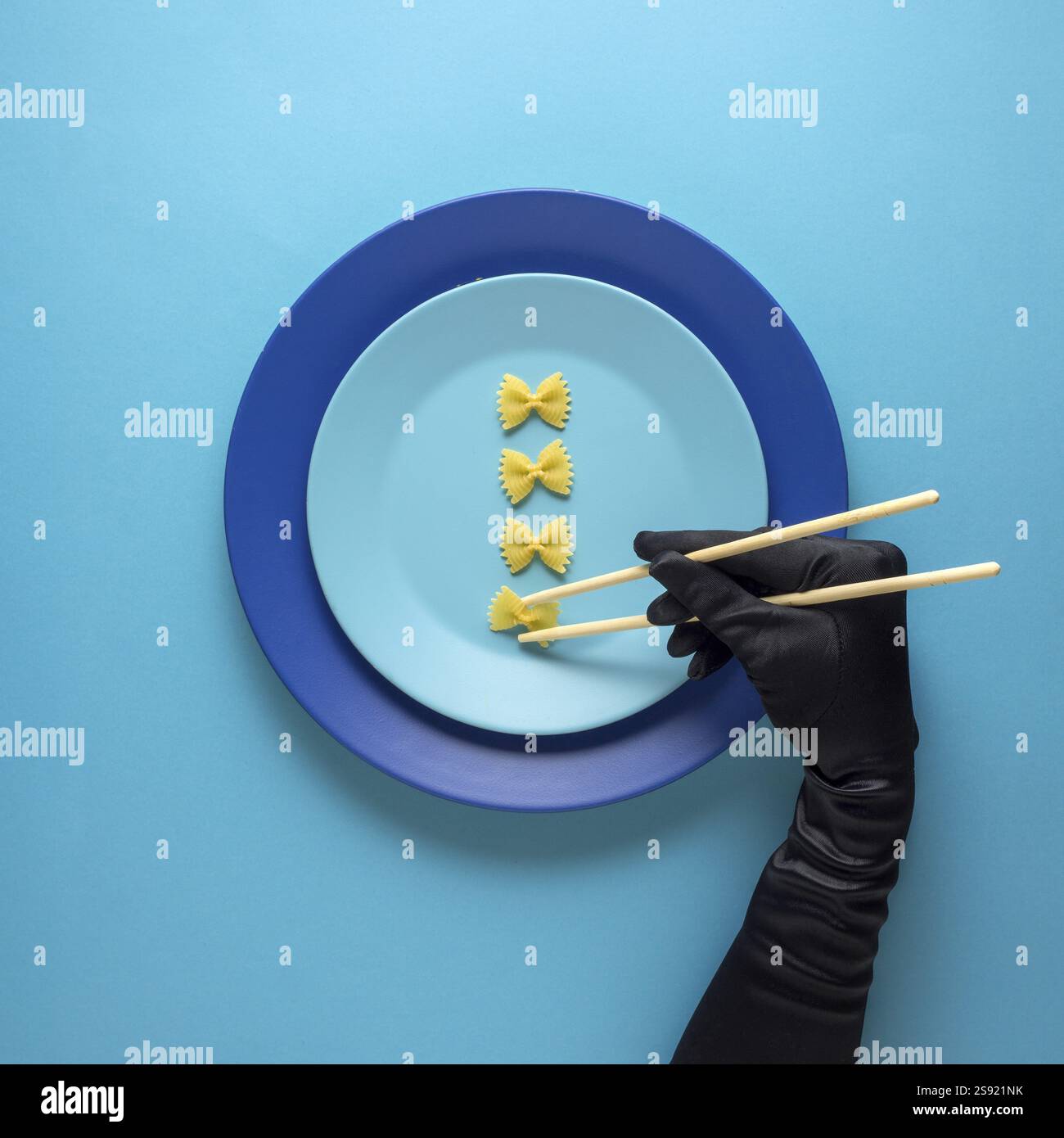 Creative concept photo of kitchenware with hand, painted plate with ...