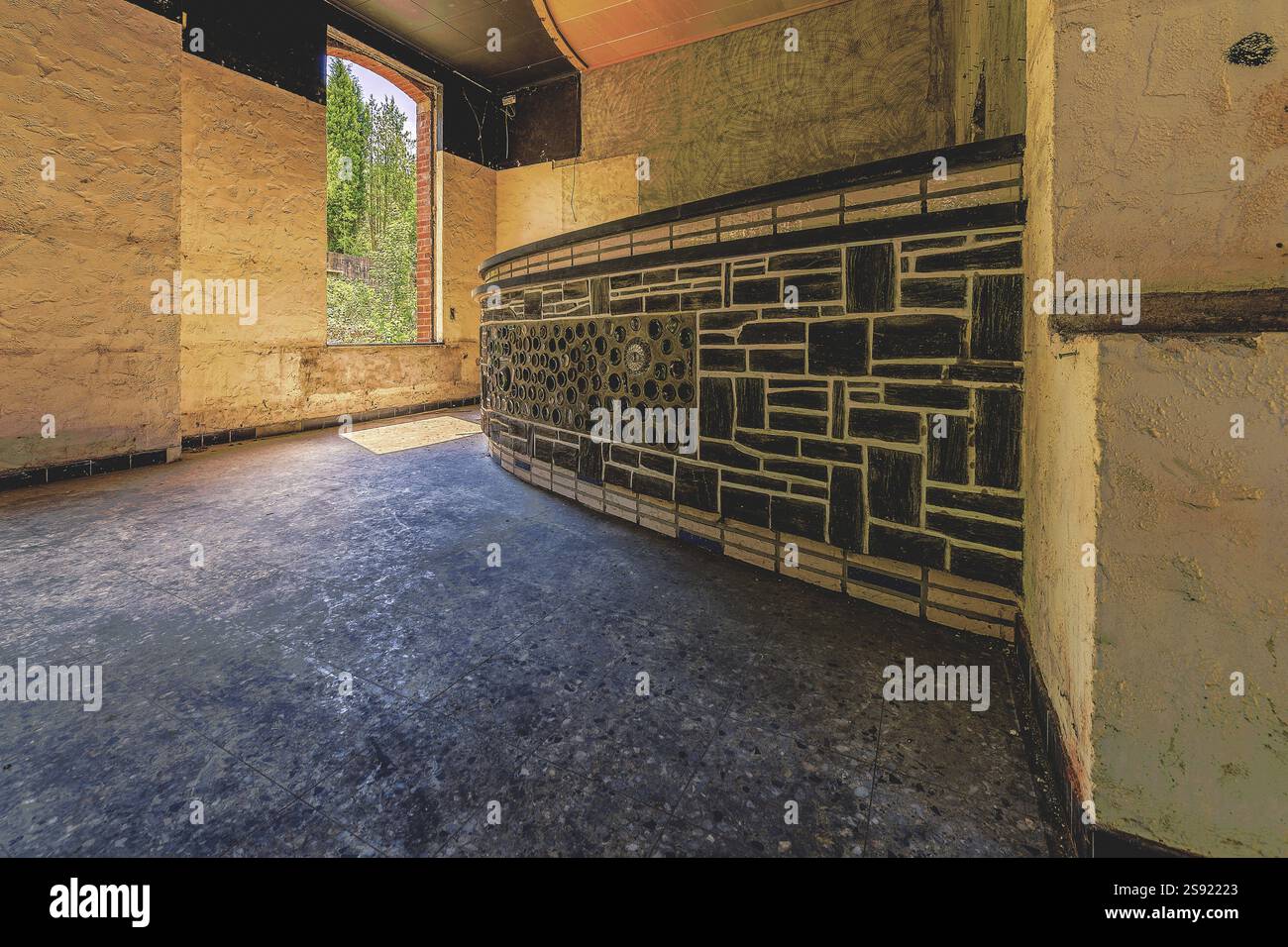 Abandoned room with patterned counter and view of the forest through ...