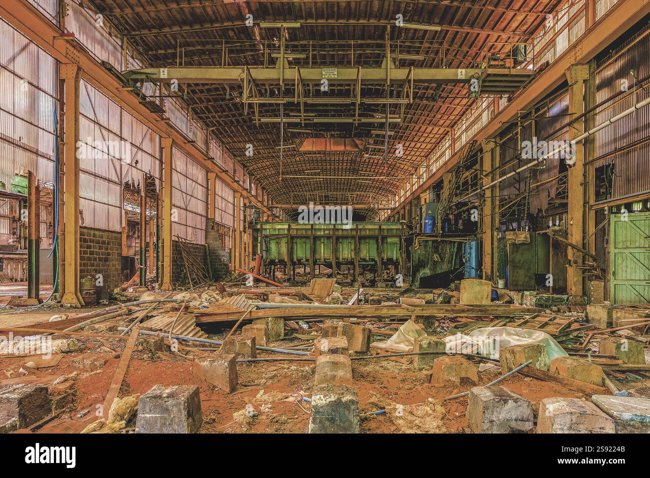 Abandoned factory building with rusty structures and debris on the ...