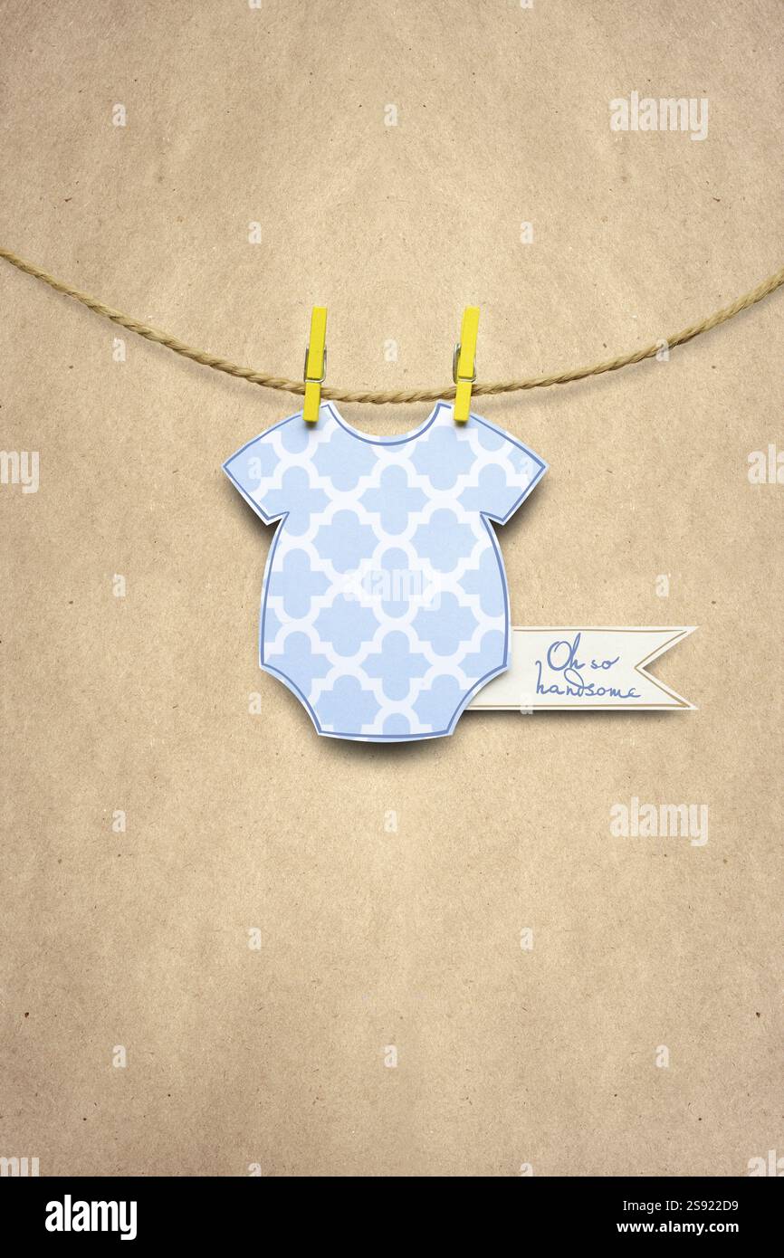 Creative concept photo of a children's jumper made of paper on a brown ...