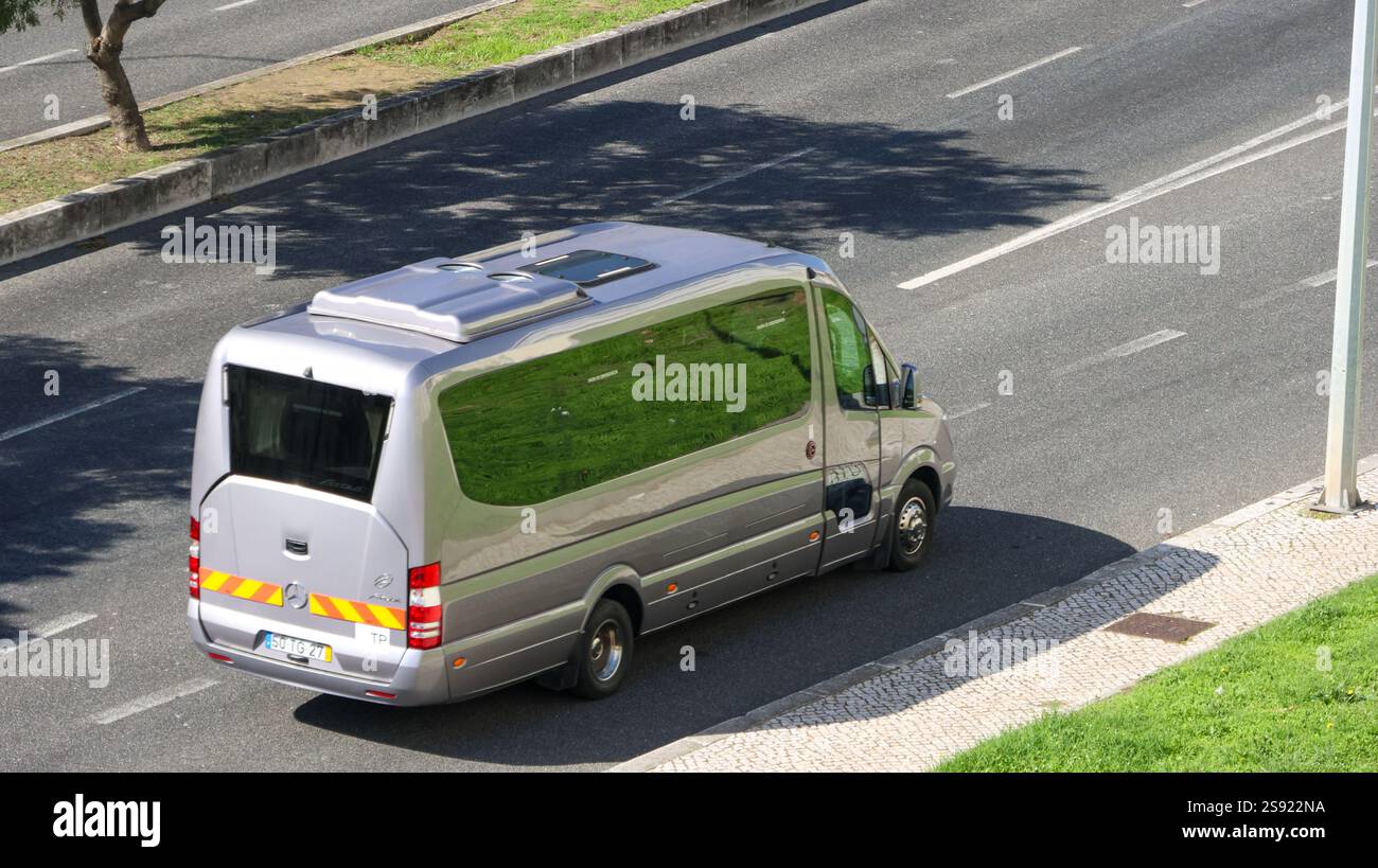 Silver mercedes benz sprinter minibus driving on a multi lane road ...